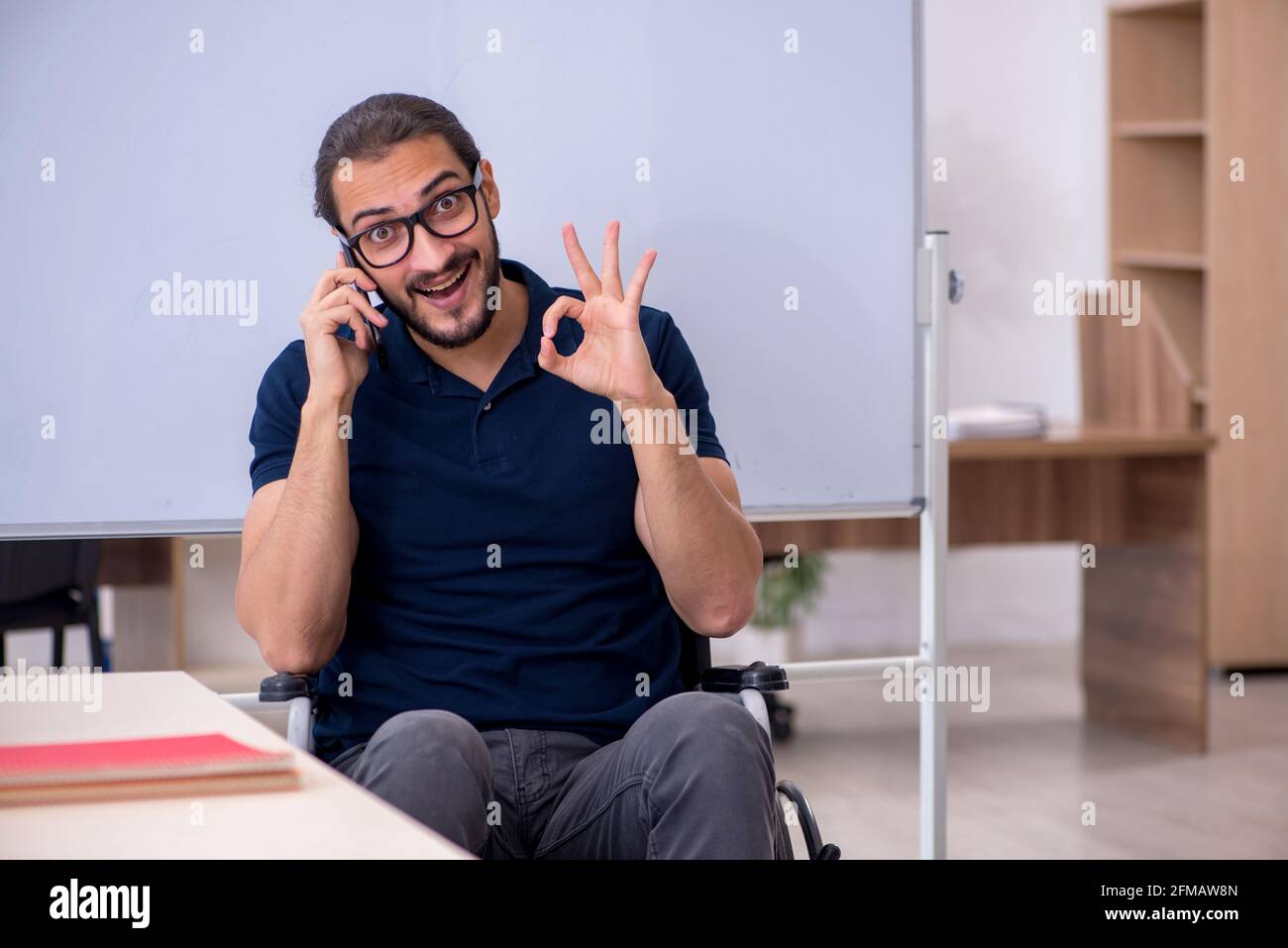Young handicapped student in the classroom Stock Photo - Alamy