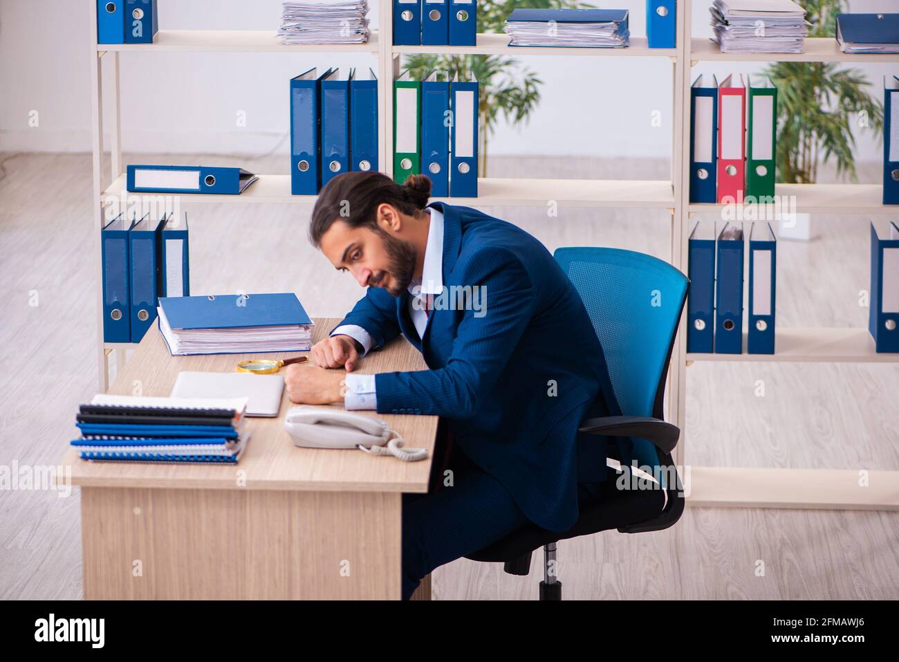 Young employee and too many work in the office Stock Photo - Alamy