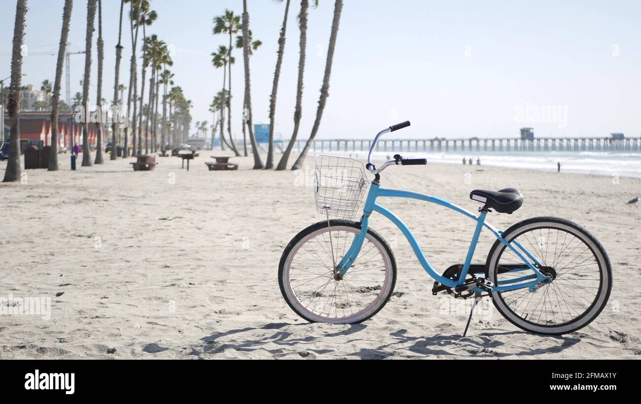 Blue bicycle, cruiser bike by sandy ocean beach, pacific coast near ...
