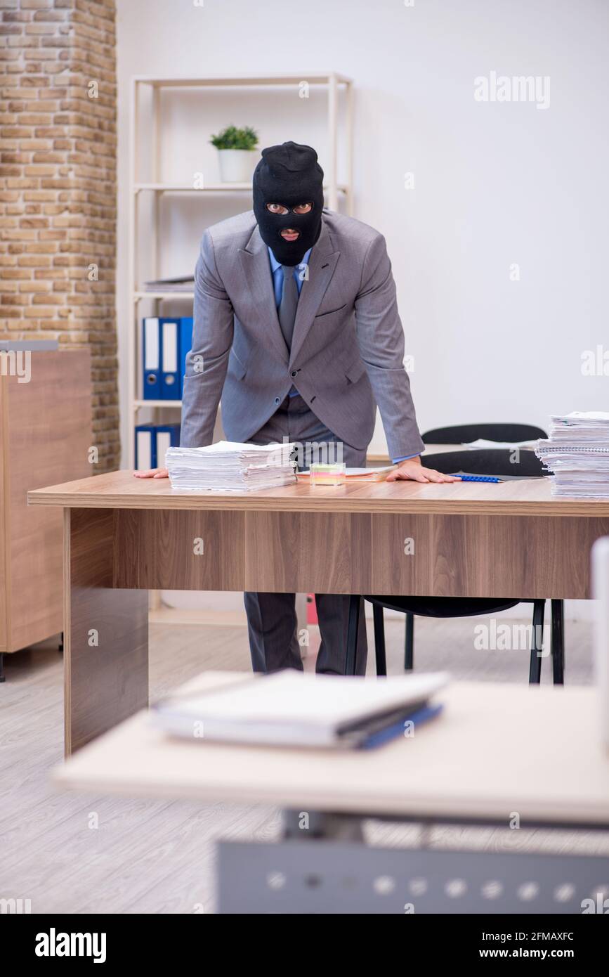 Young employee in industrial espionage concept Stock Photo - Alamy