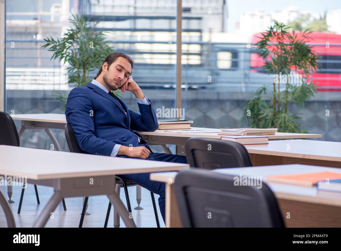 Young teacher in suit in the classroom Stock Photo - Alamy