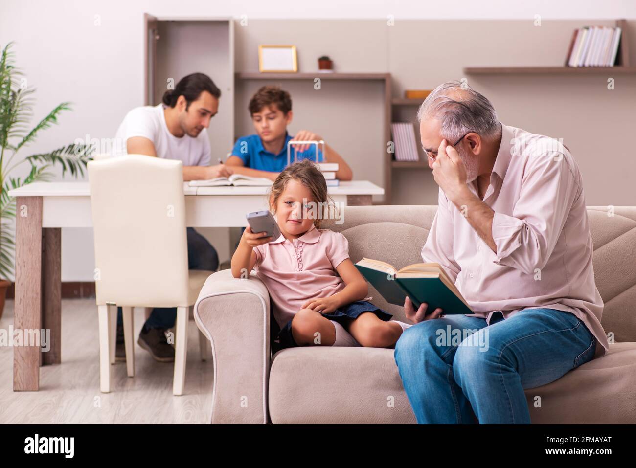 Three generations at home in early development concept Stock Photo - Alamy