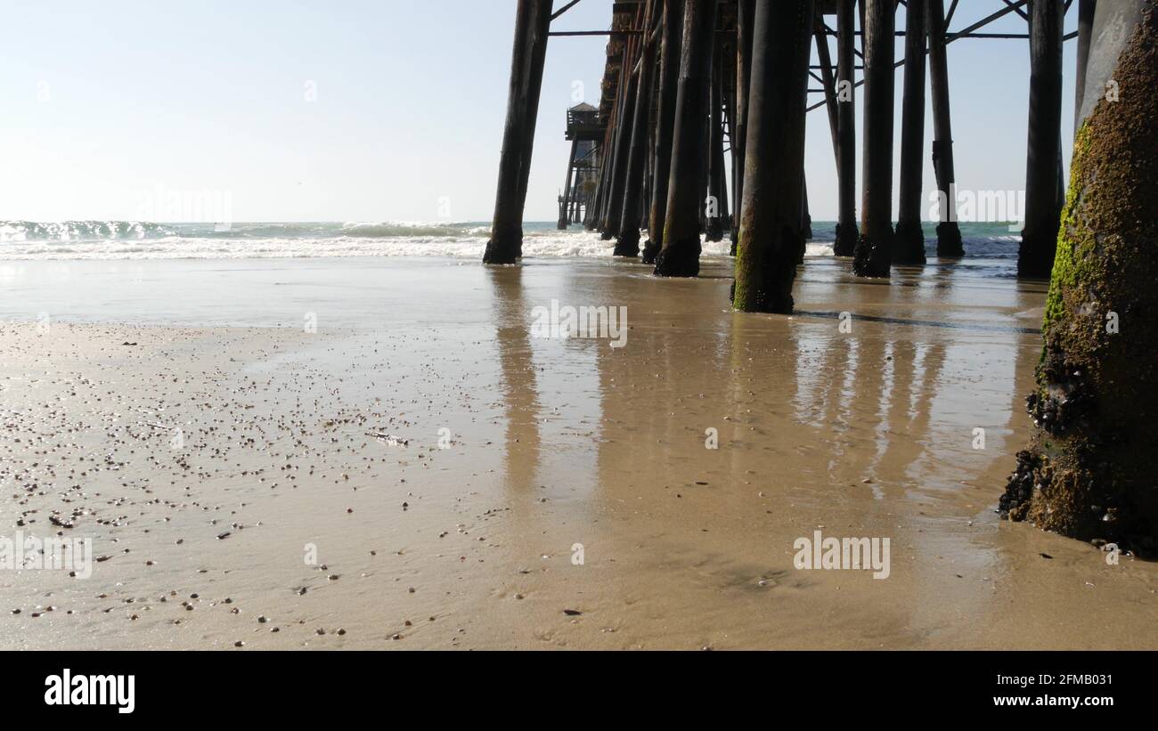 Wooden piles under boardwalk, old pier in Oceanside, California coast ...