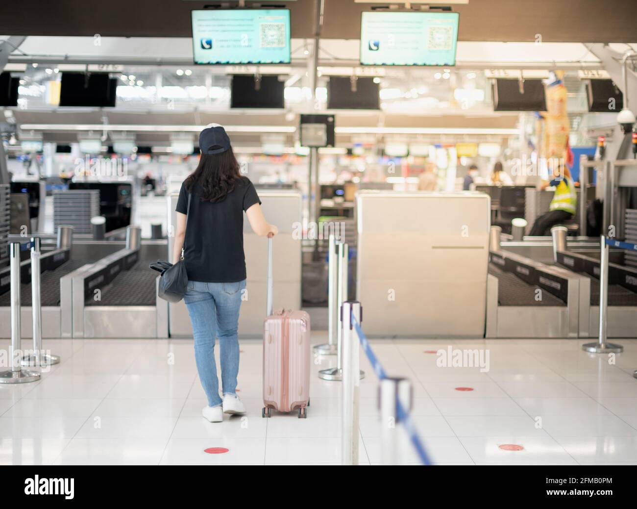 The back view of asian woman traveler carrying luggage prepare to check ...
