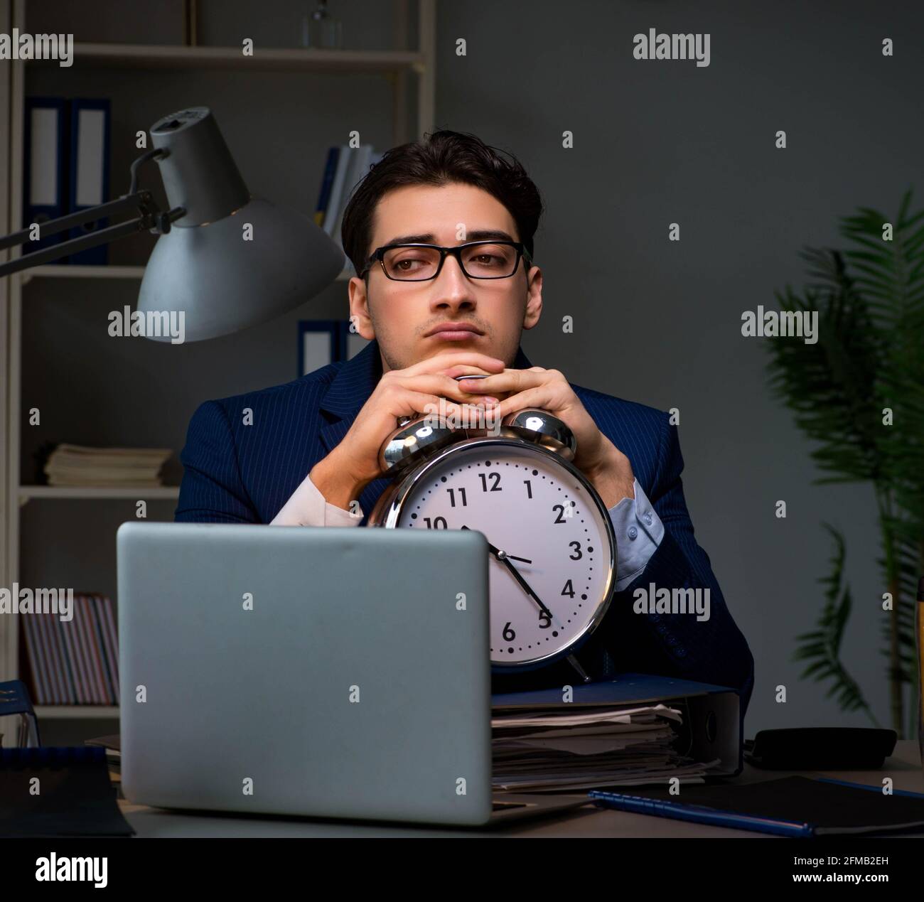 The employee staying late to finish work on auditing Stock Photo - Alamy