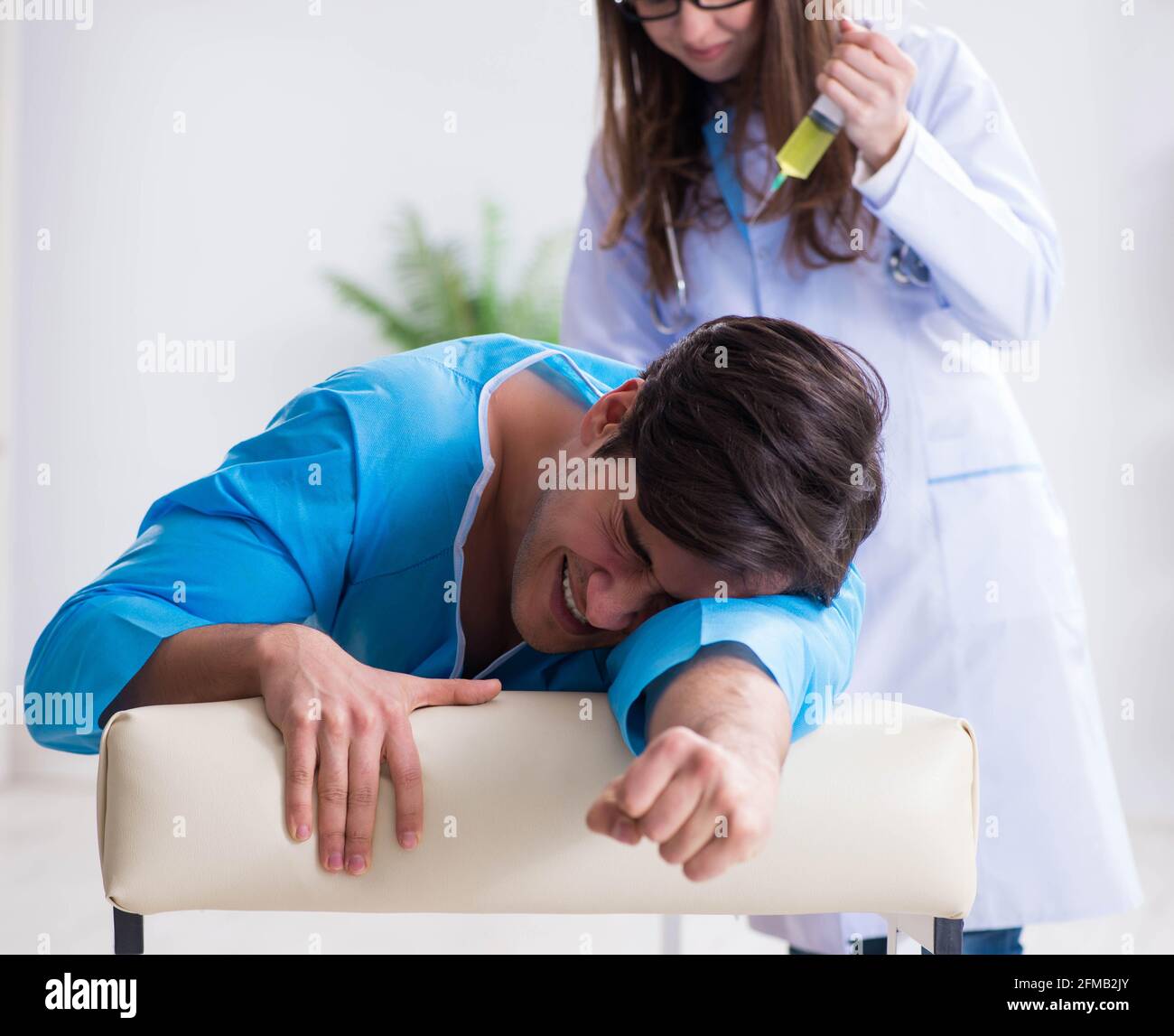 The funny man getting ready for buttocks syringe shot Stock Photo - Alamy
