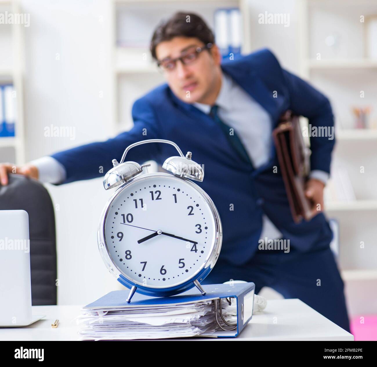 The businessman in bad time management concept Stock Photo - Alamy