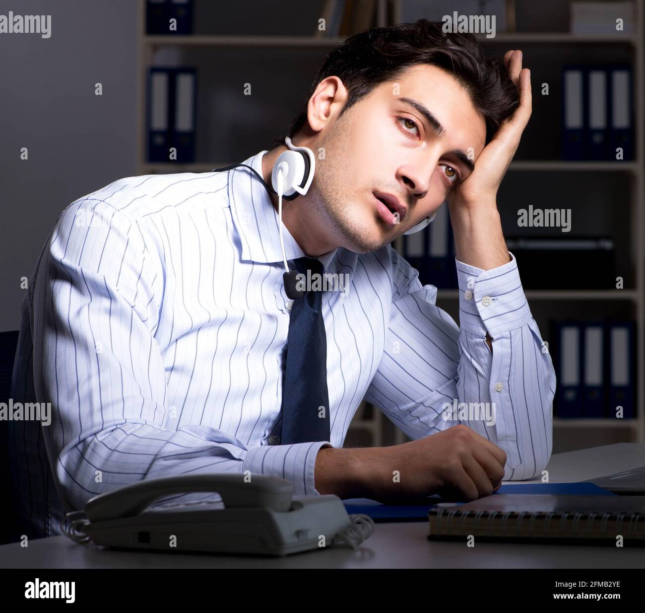 The tired and exhausted helpdesk operator during night shift Stock ...