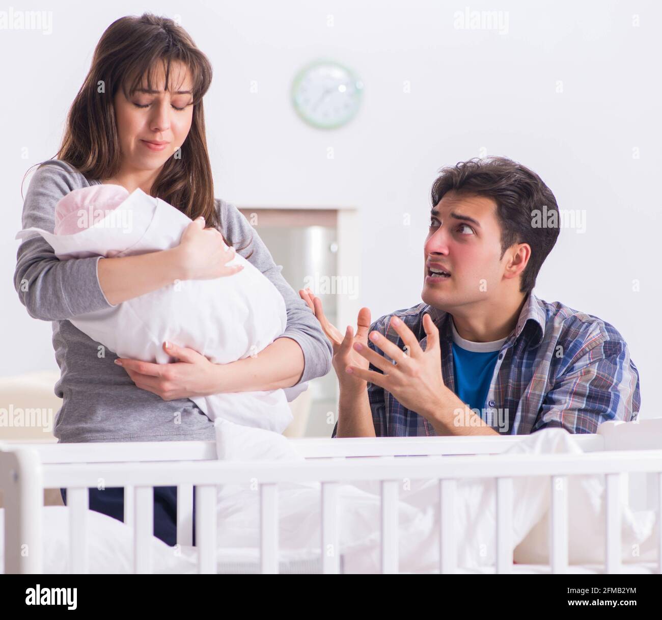 The young dad cannot stand baby crying Stock Photo - Alamy