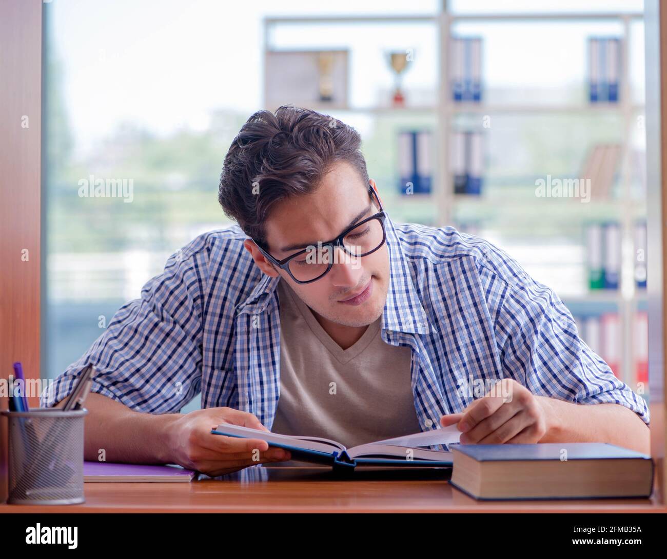 The student studying at home preparing for exam Stock Photo - Alamy