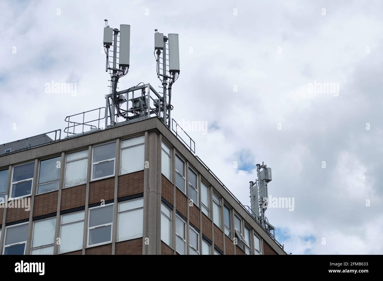 Cell site placed atop a concrete building Stock Photo - Alamy