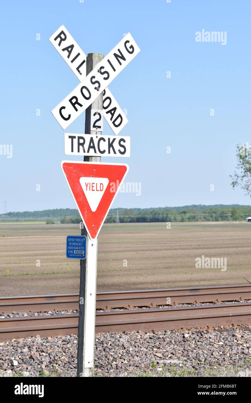 Railroad crossing sign by a railroad track in rural United States Stock ...