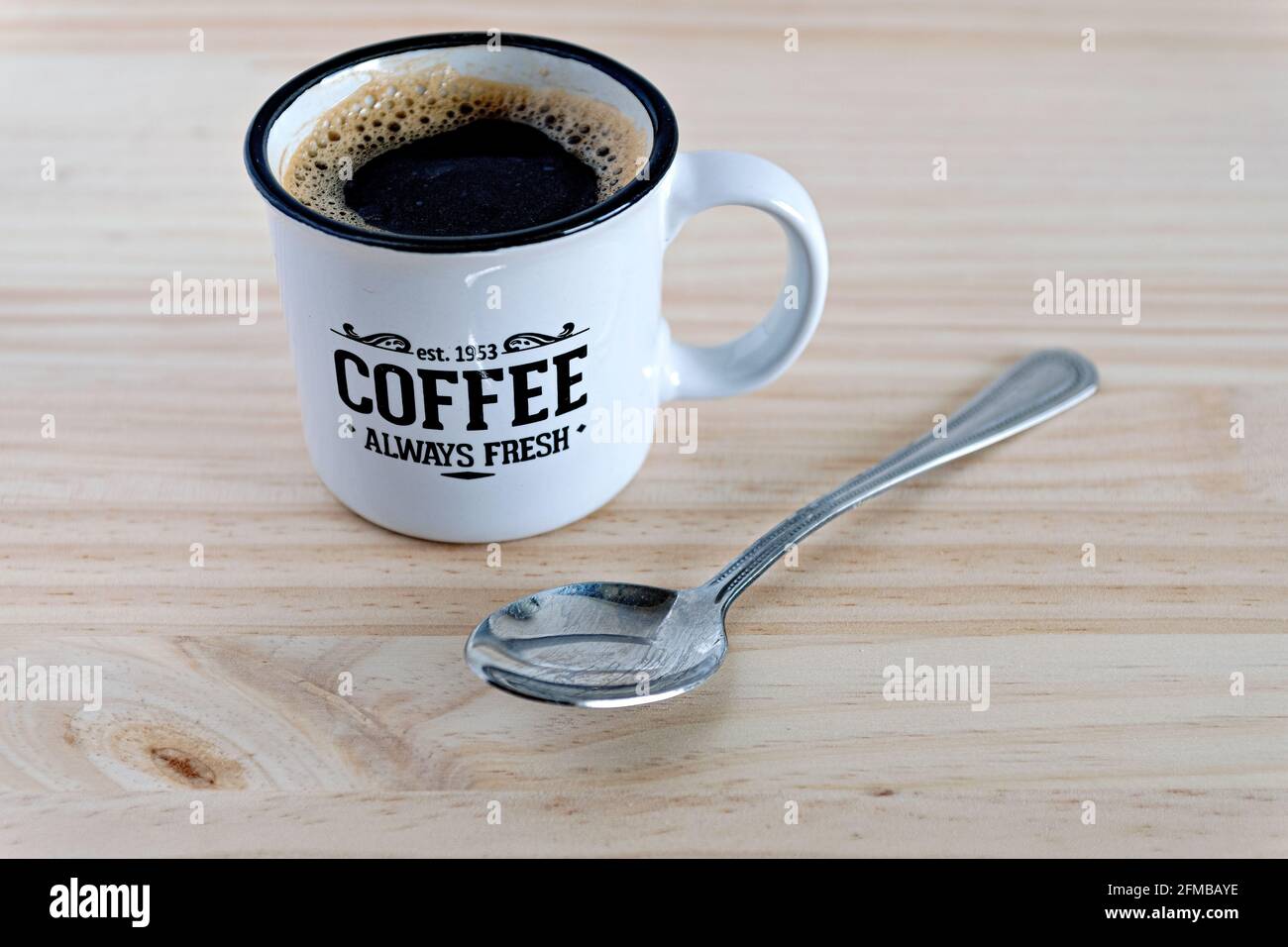 Closeup shot of a fresh cup of coffee with a spoon Stock Photo - Alamy