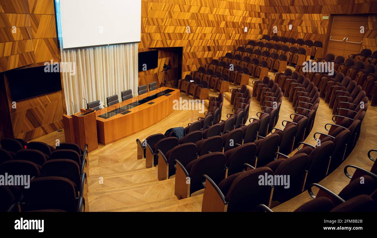 Large venue with a presentation stage and empty seats Stock Photo - Alamy