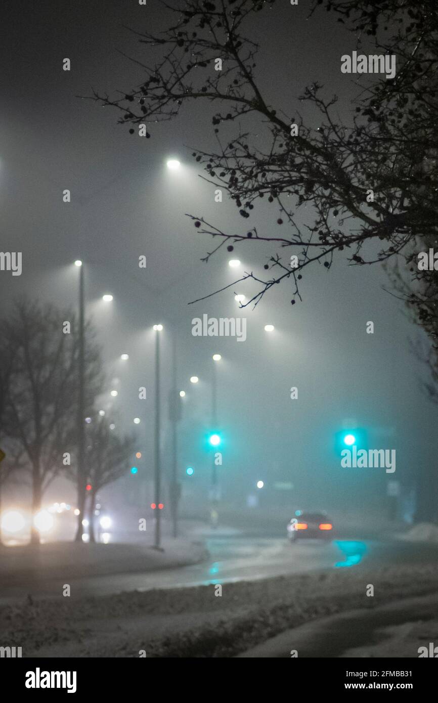 Snow on suburban street at night hi-res stock photography and images ...