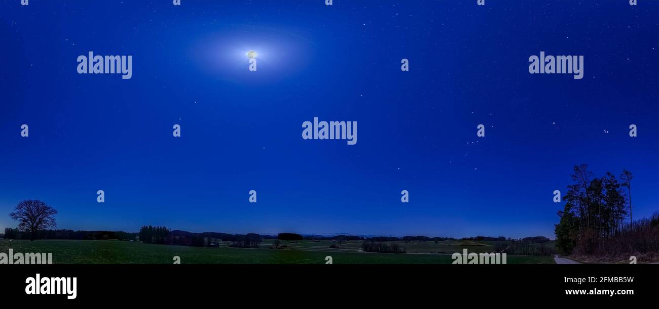 Alpine panorama with a full moon Stock Photo - Alamy