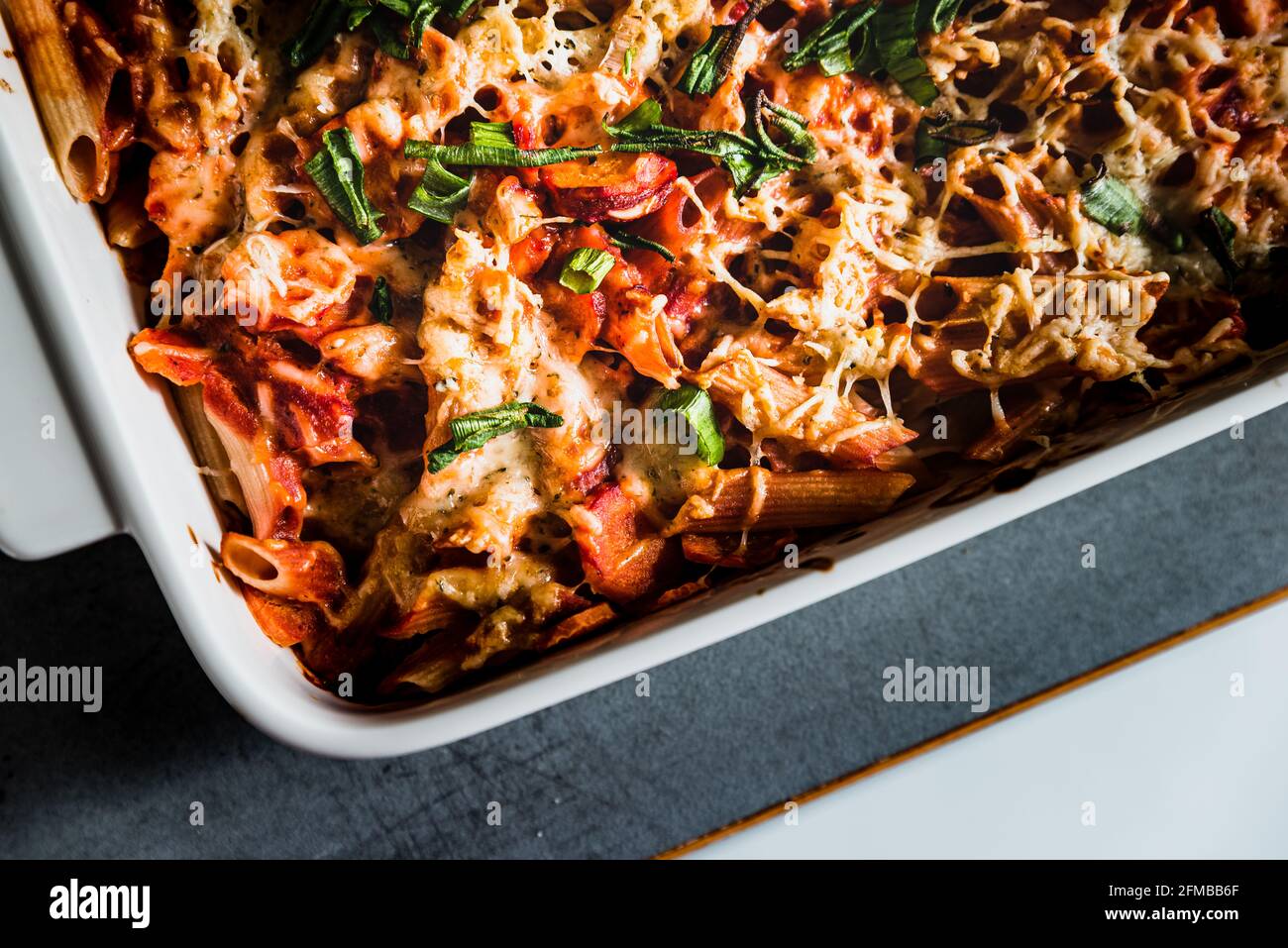 Baked pasta casserole in a white baking dish fresh from the oven Stock ...