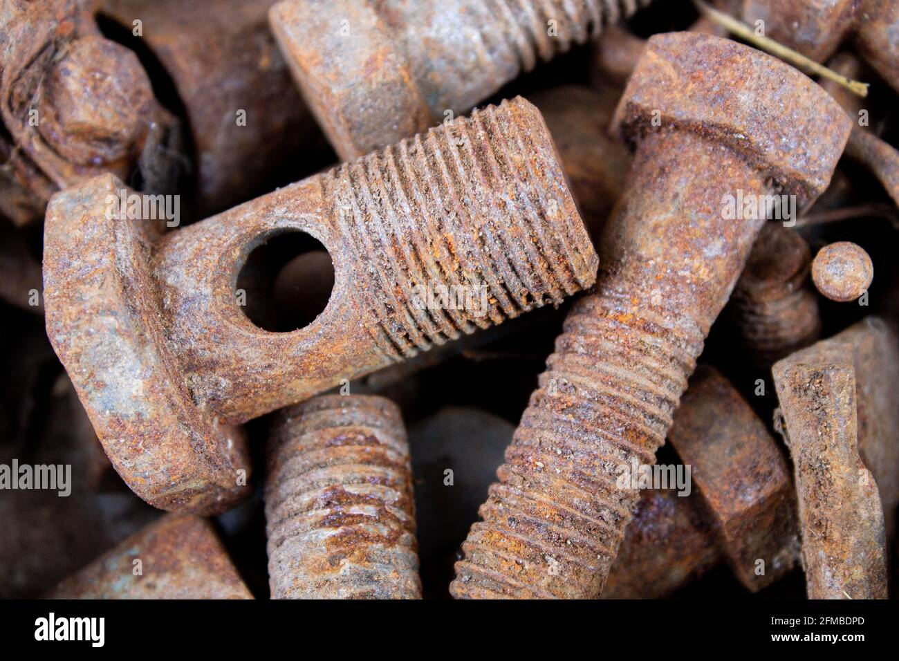 Old rusty bolts and nuts. Fasteners on the trash can. The iron bolts ...