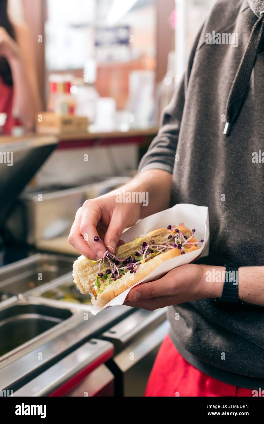 Hotdog - friendly salesman and fresh ingredients in a fast food snack ...