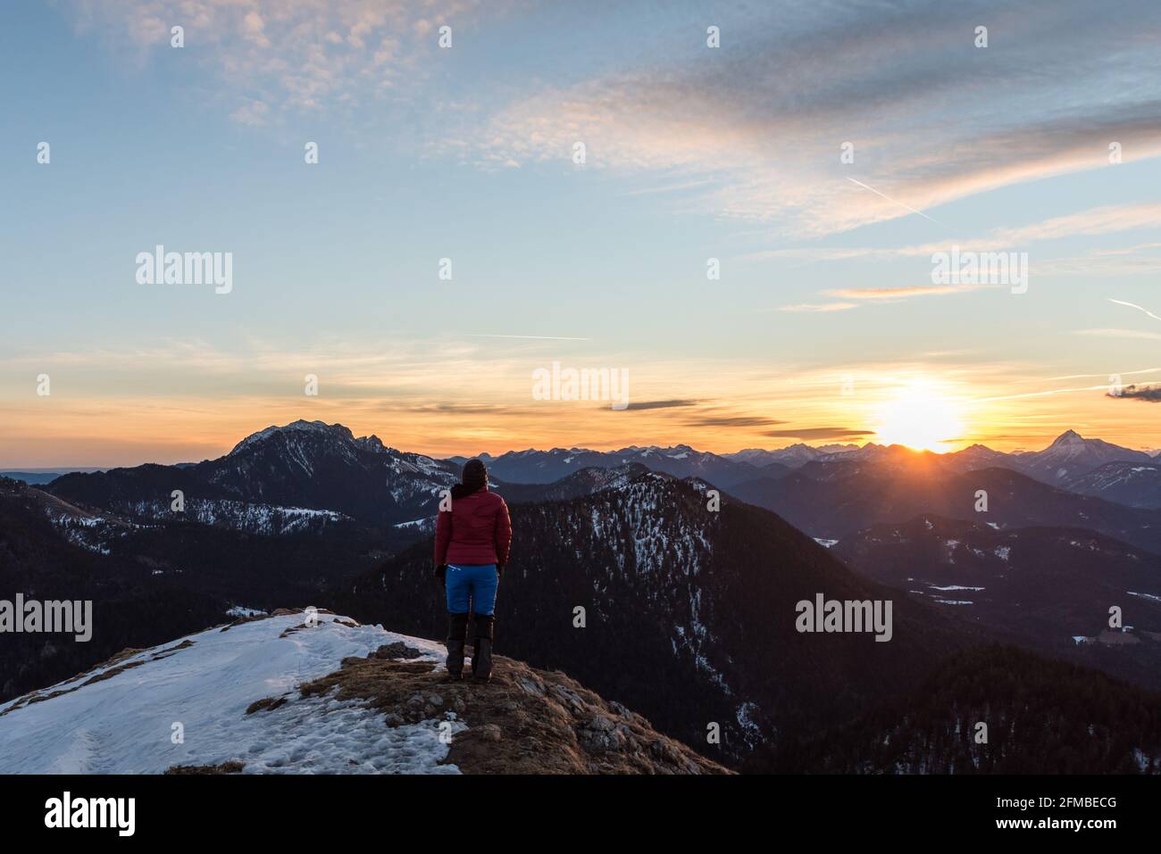 A hiker on the Jochberg with a view of the sunrise Stock Photo - Alamy