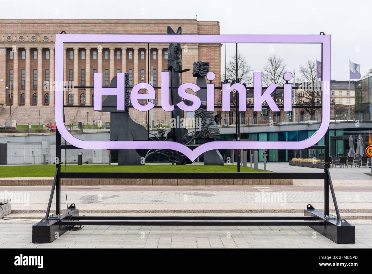 Helsinki sign with light with the Parliament house in the background at ...