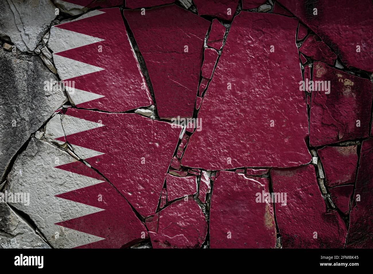National flag of Qatar depicting in paint colors on an old stone wall ...