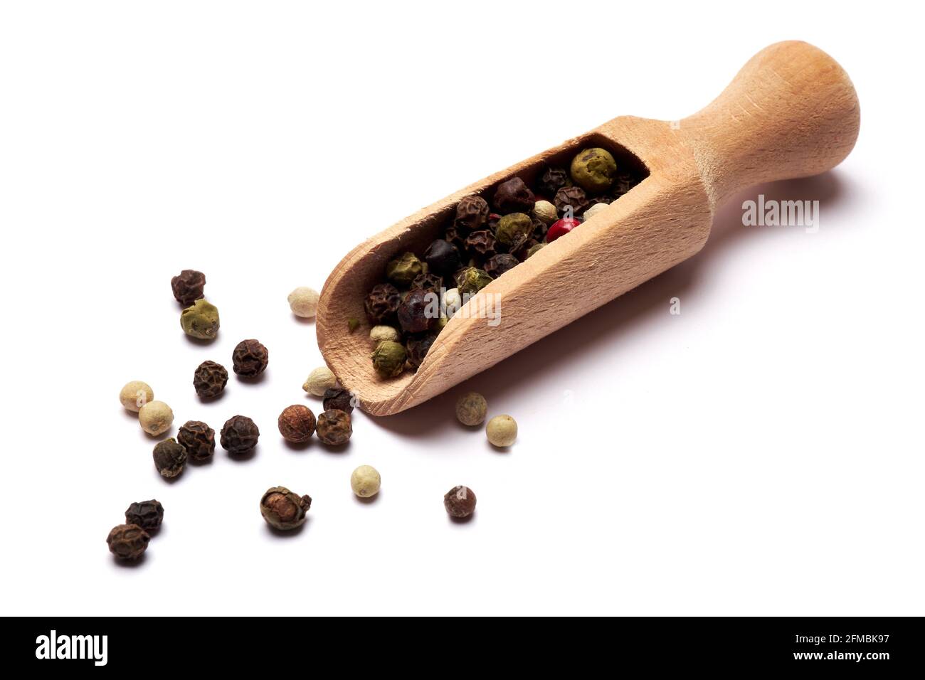 wooden scoop with black round pepper spice on white background Stock ...