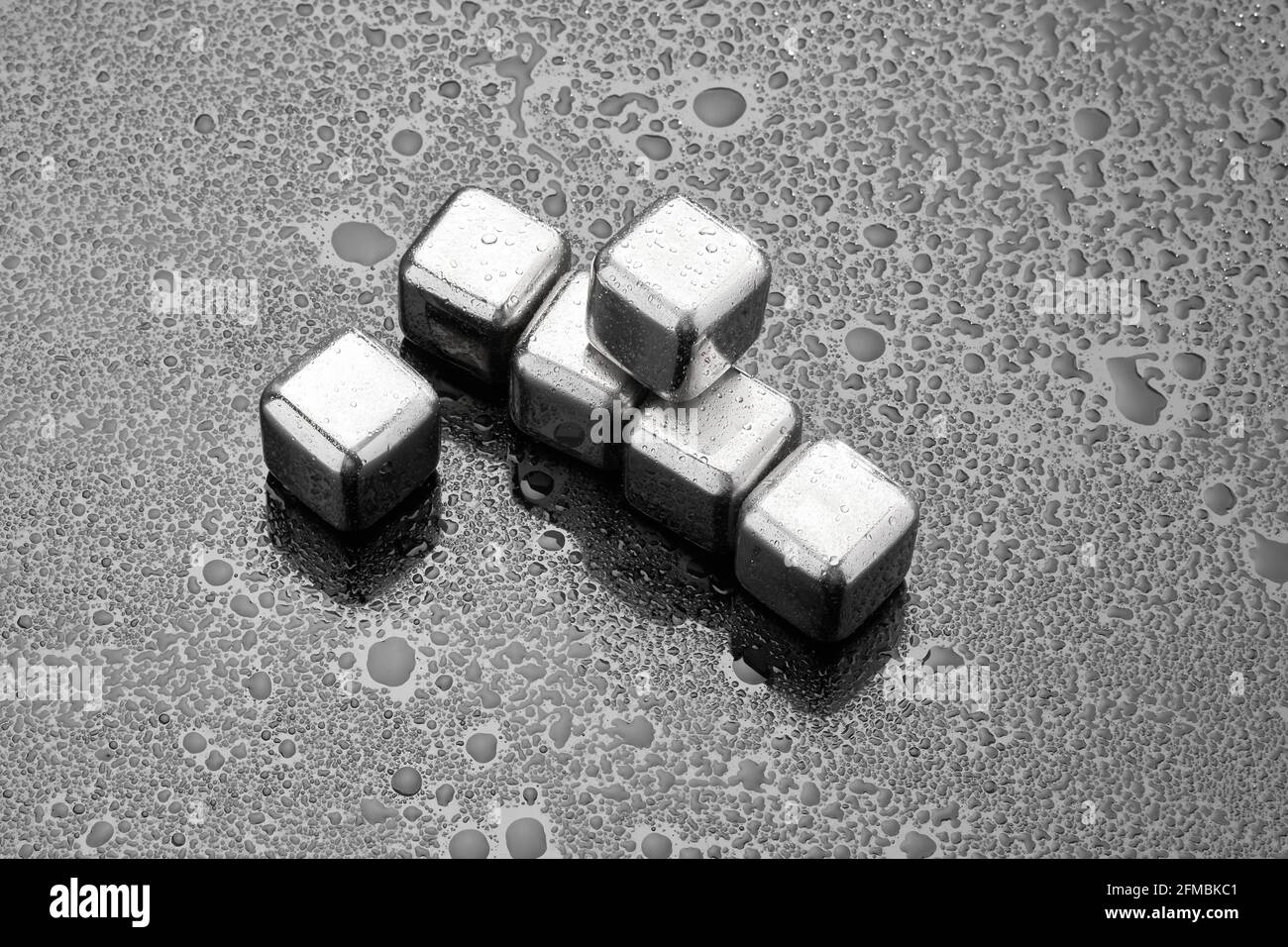 Steel cooling cubes for cocktail drink on glass background Stock Photo ...