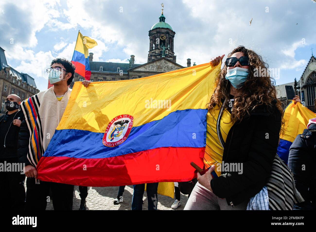 Protesters hold a Colombian flag during the demonstration. Tens of ...