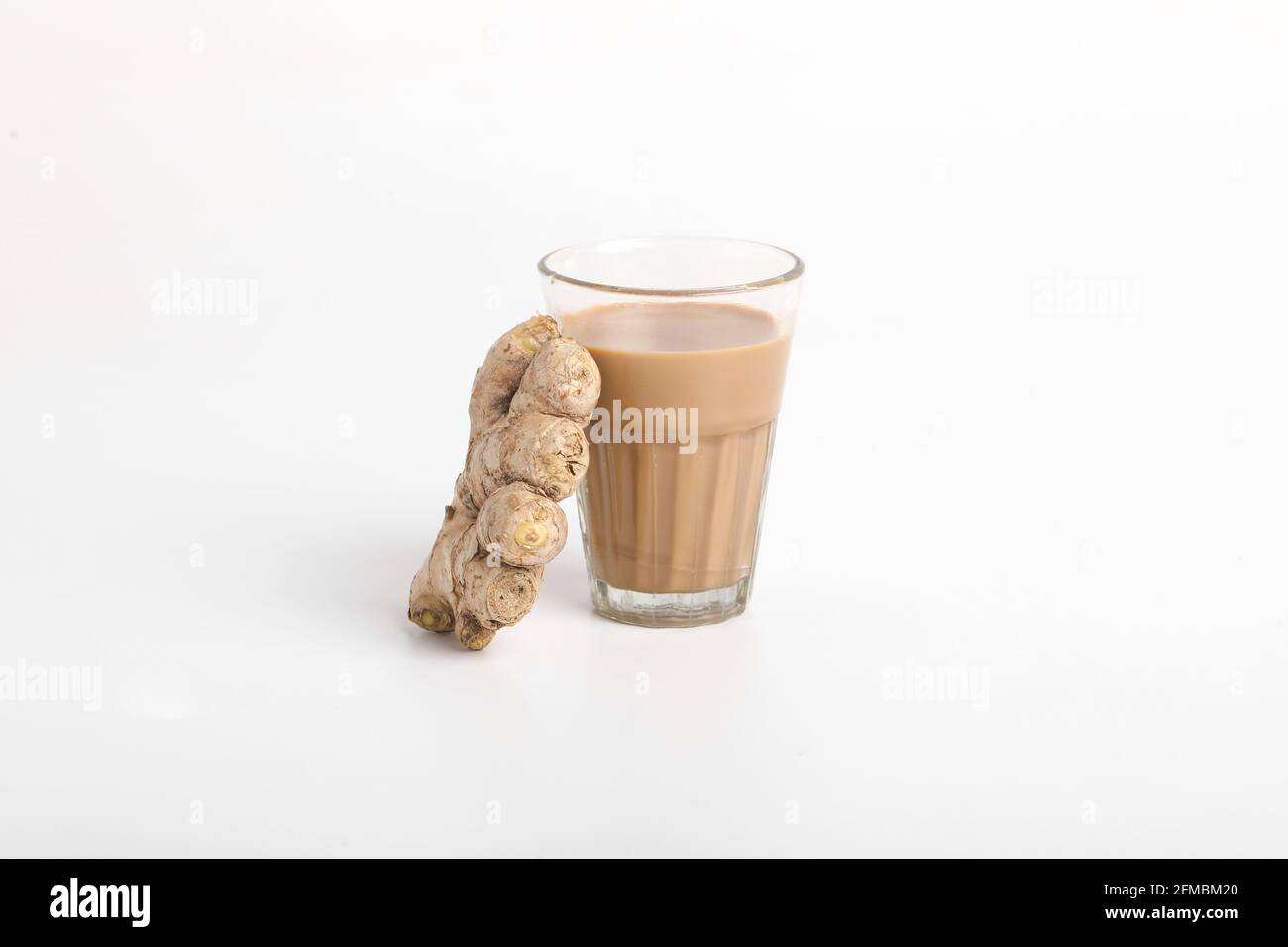 Glass cup of hot ginger tea with ginger rhizome (root) sliced isolated ...