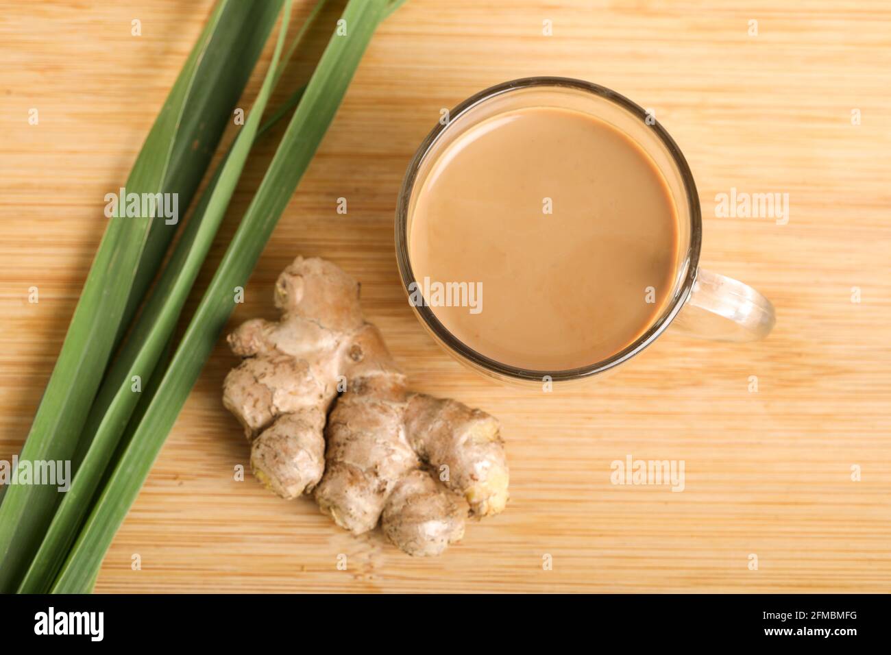 Glass cup of hot ginger tea with ginger rhizome (root) sliced isolated ...
