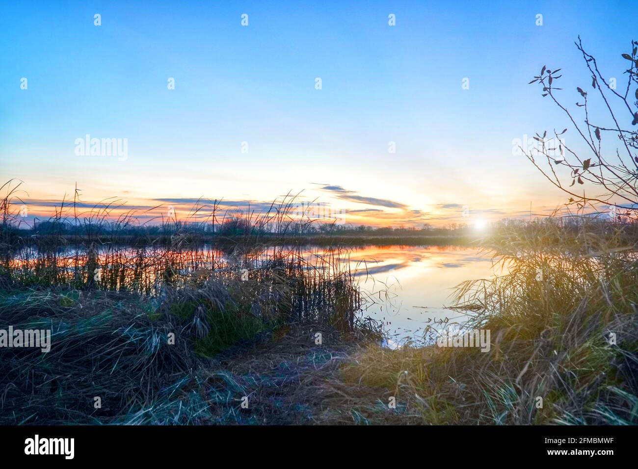 Beautiful sunset over a small river. Evening landscape Stock Photo - Alamy