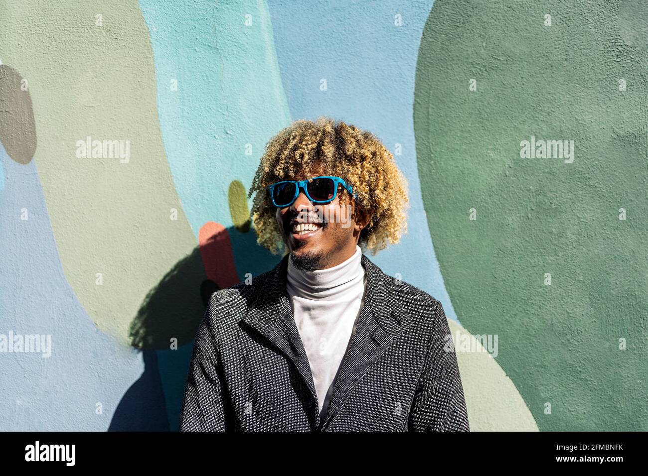 Handsome smart african man listening music using mobile phone at the street Stock Photo - Alamy