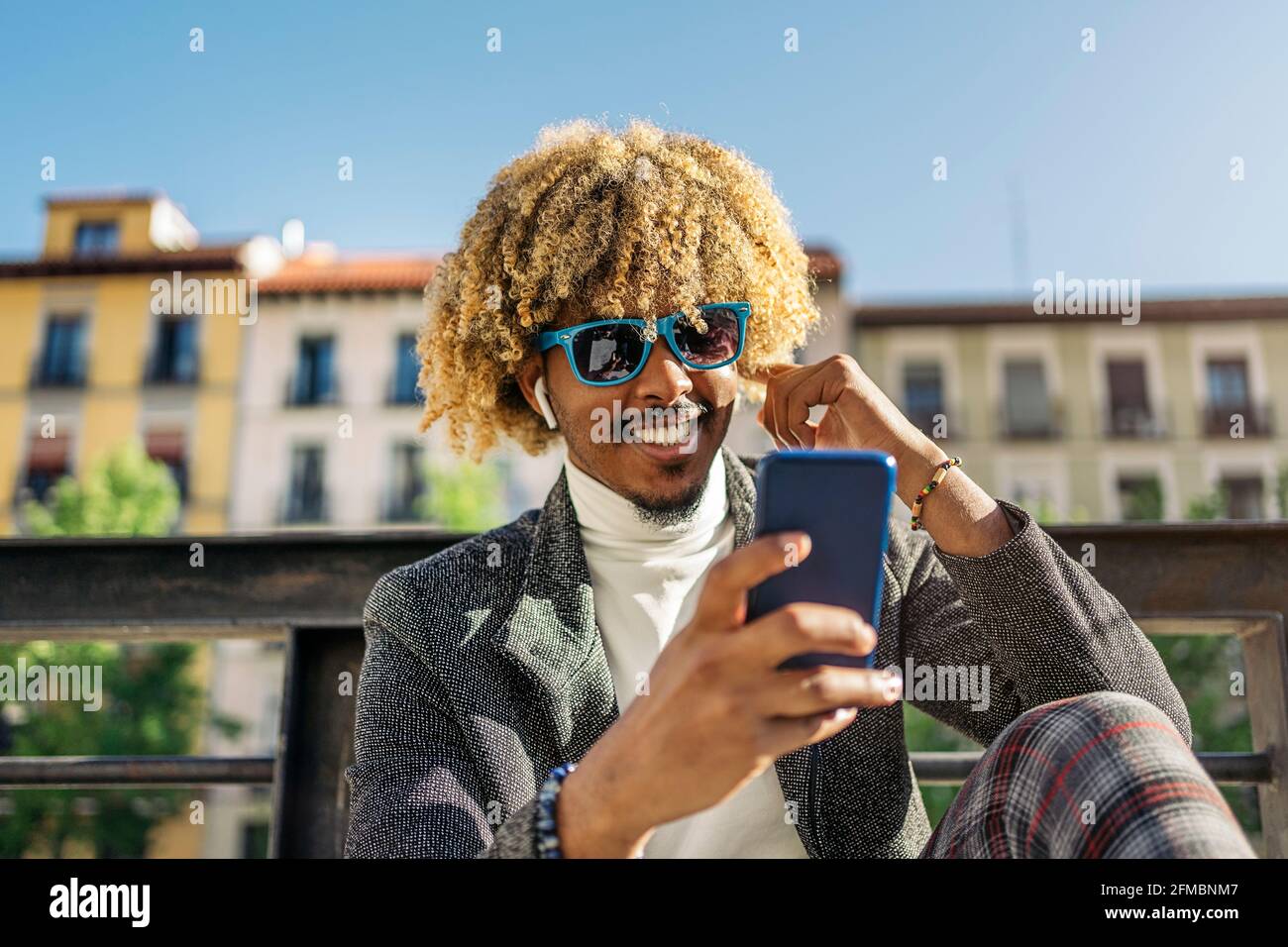 Handsome smart african man talking using a mobile phone at the street. Communication concept ...