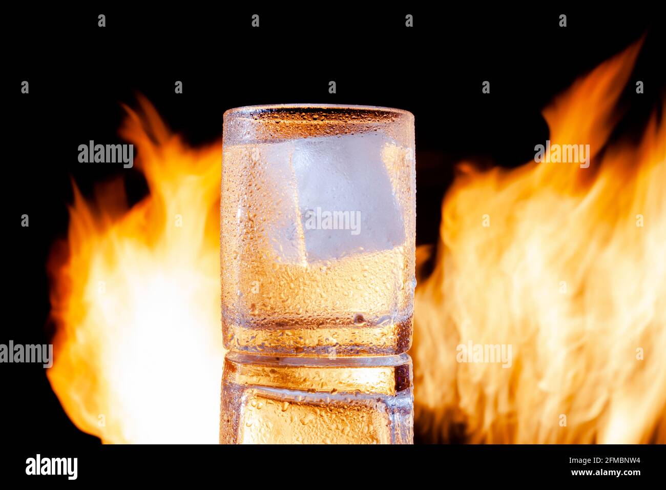 glass of vodka on a black background on fire Stock Photo - Alamy