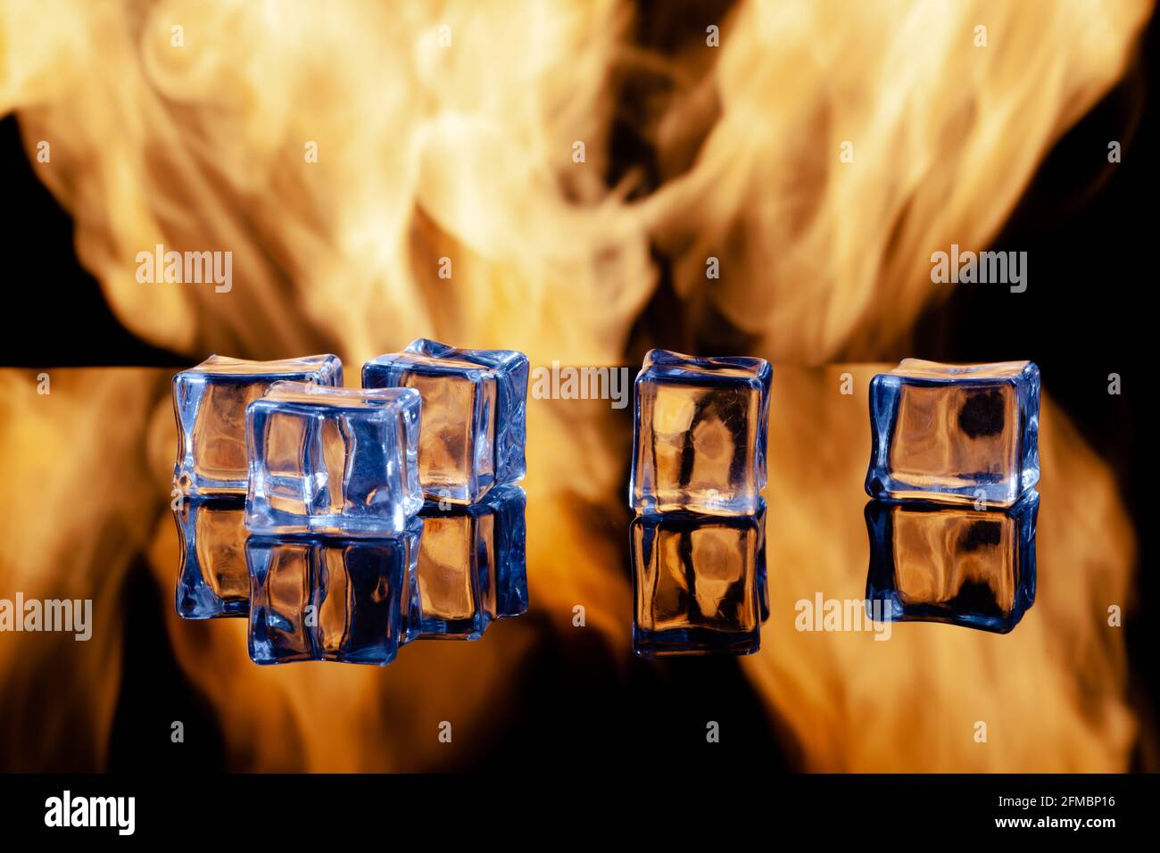five ice cubes against the background of fire Stock Photo - Alamy