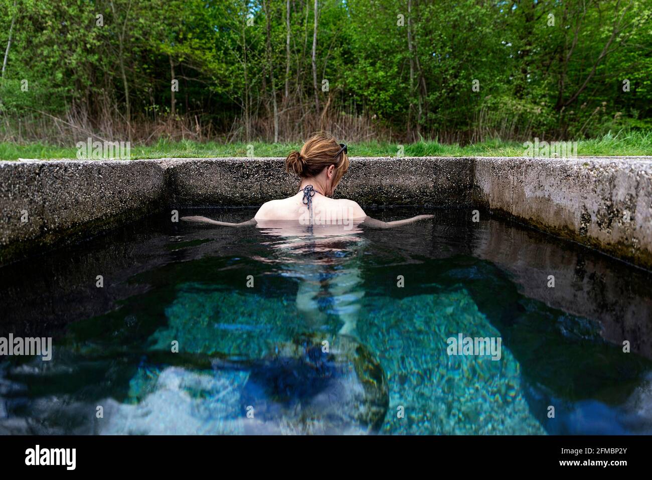 Woman relaxing in outdoor hot spring Stock Photo - Alamy