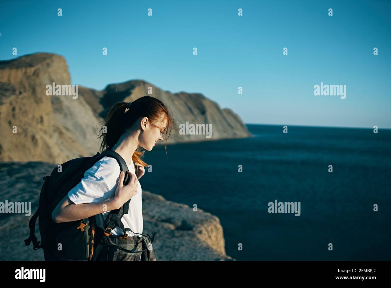 traveler near the sea in nature with a backpack Stock Photo - Alamy
