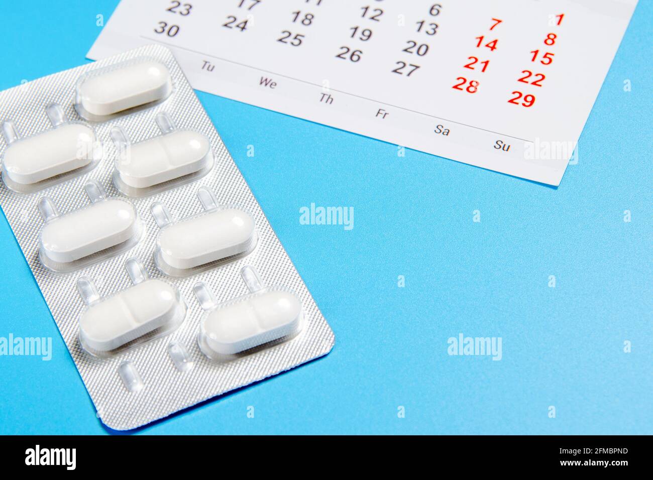 blister of pills with calendar on blue background. doctor treatment ...