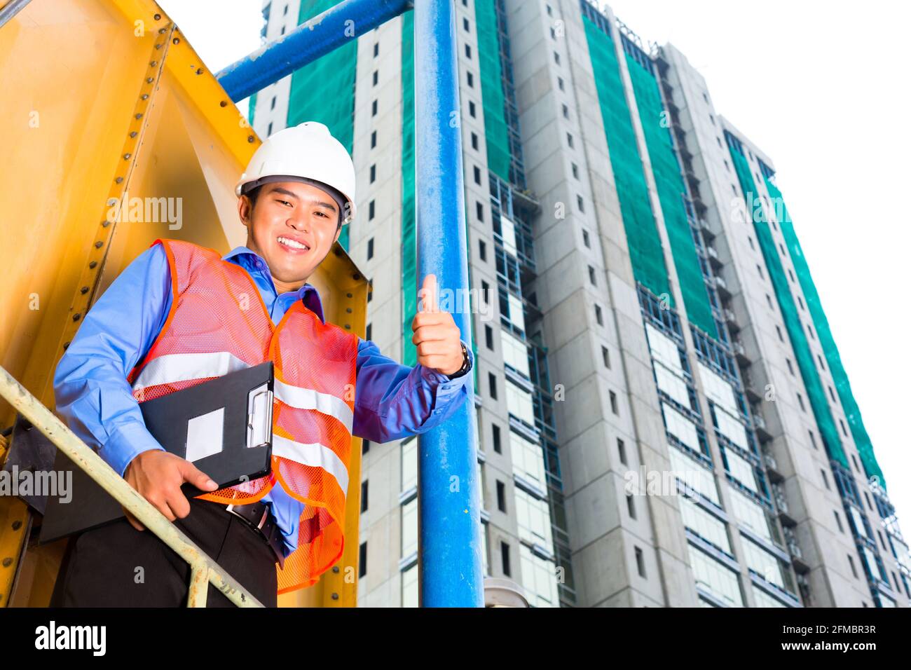 Chinese construction worker or supervisor or architect with clipboard ...