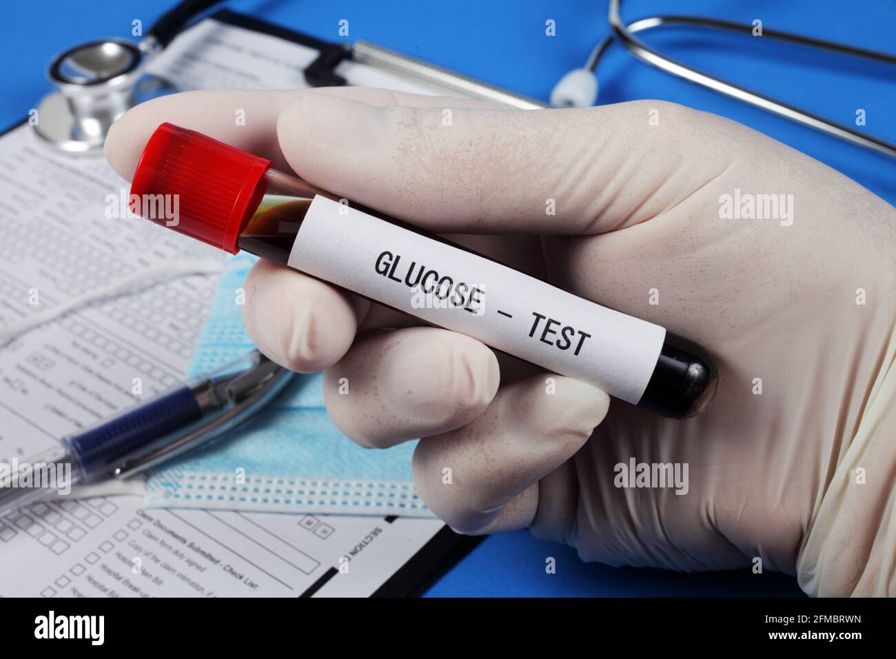 Glucose test , vacuum tube with blood in the doctor's hand, selective ...