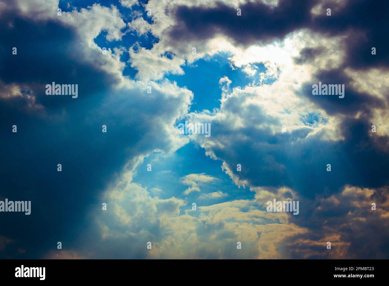 Cloudy sky with points of translucent sun rays Stock Photo - Alamy