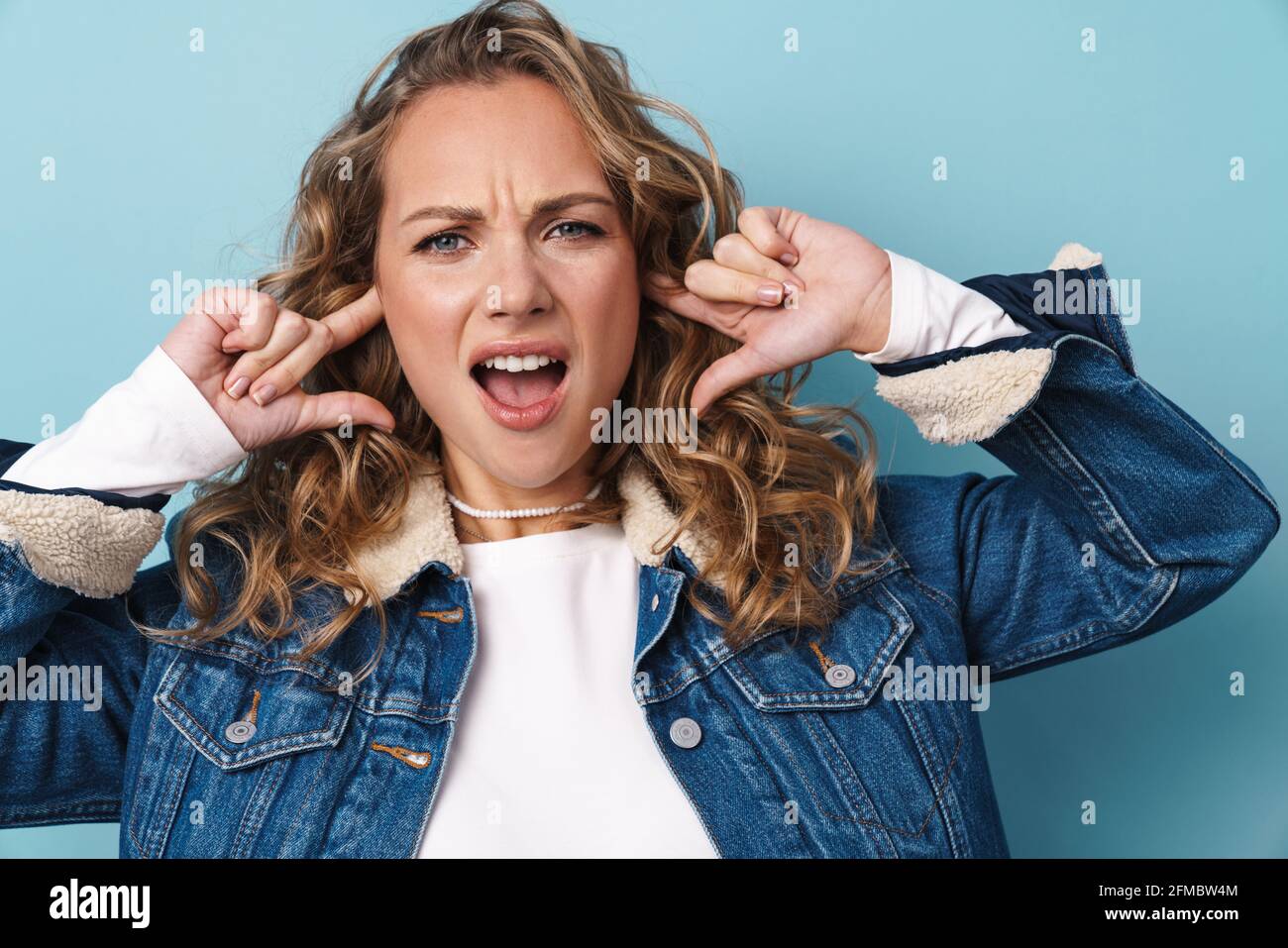 Woman plugging ears hi-res stock photography and images - Alamy
