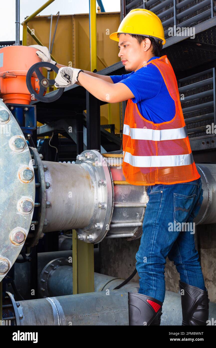 technician or engineer working on a valve on building technical ...
