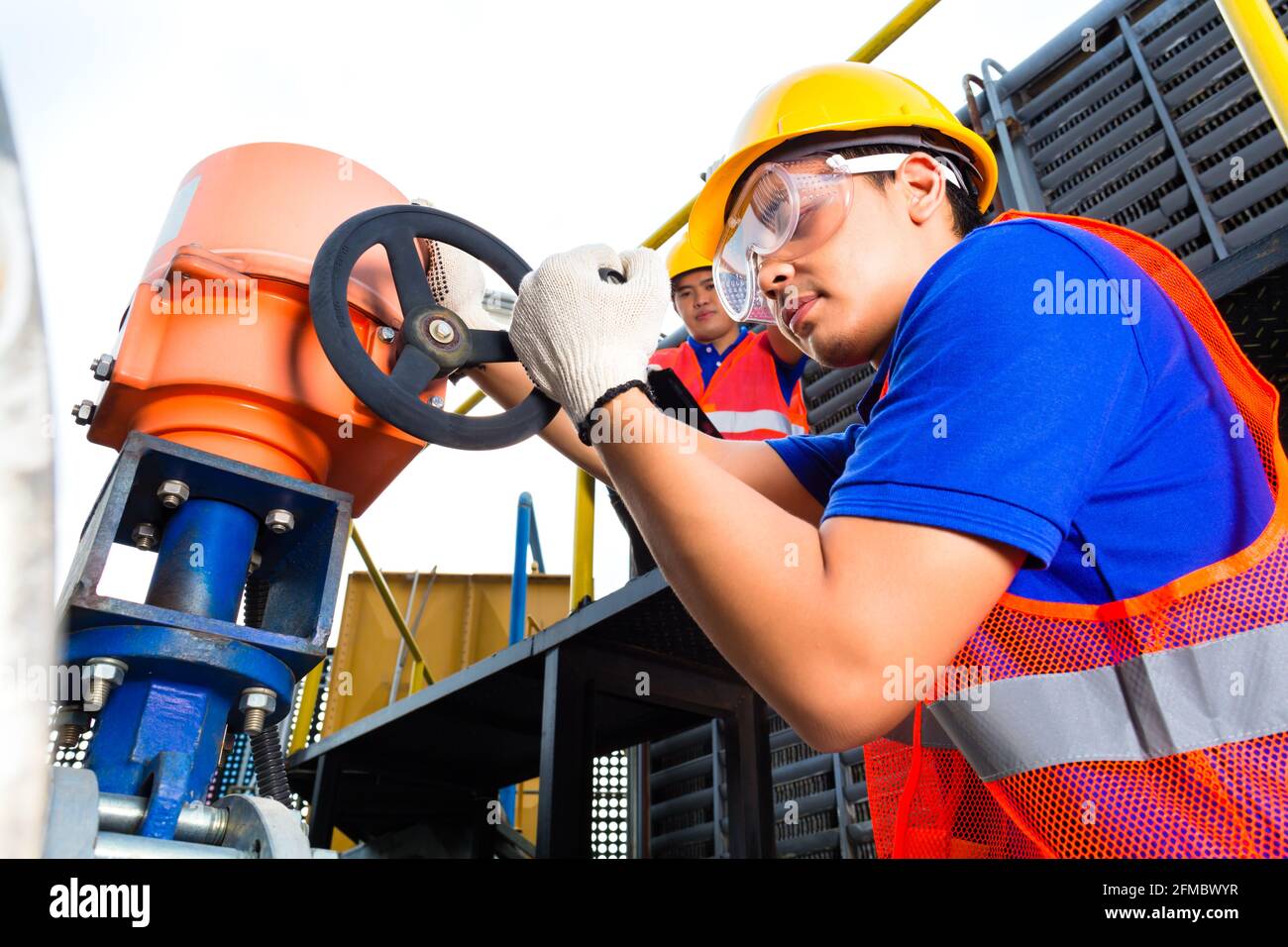 In utility or factory ewo technicians or engineers working on a valve ...