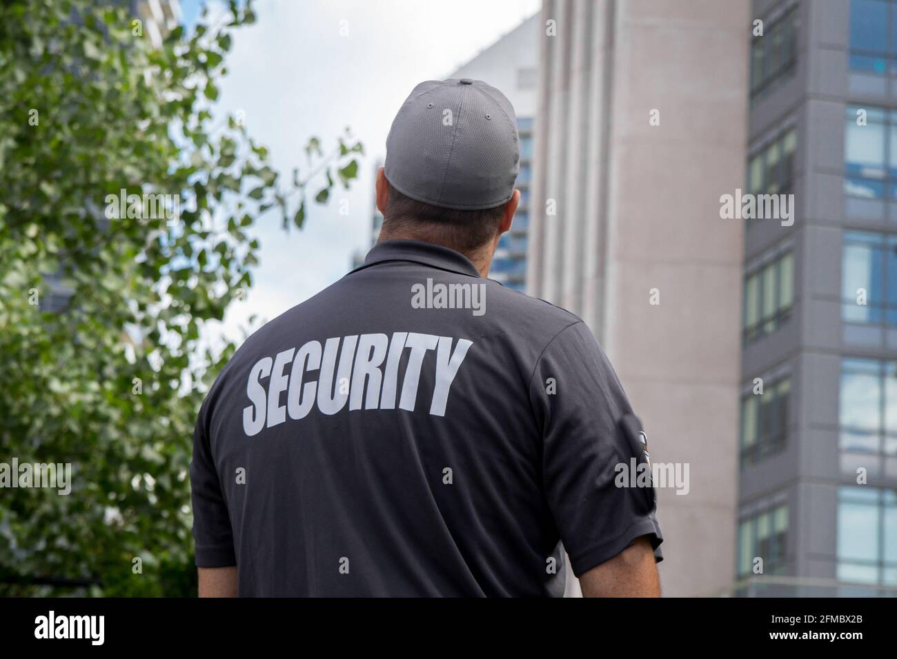 Tall security guard in a uniform patrolling condo area Stock Photo - Alamy