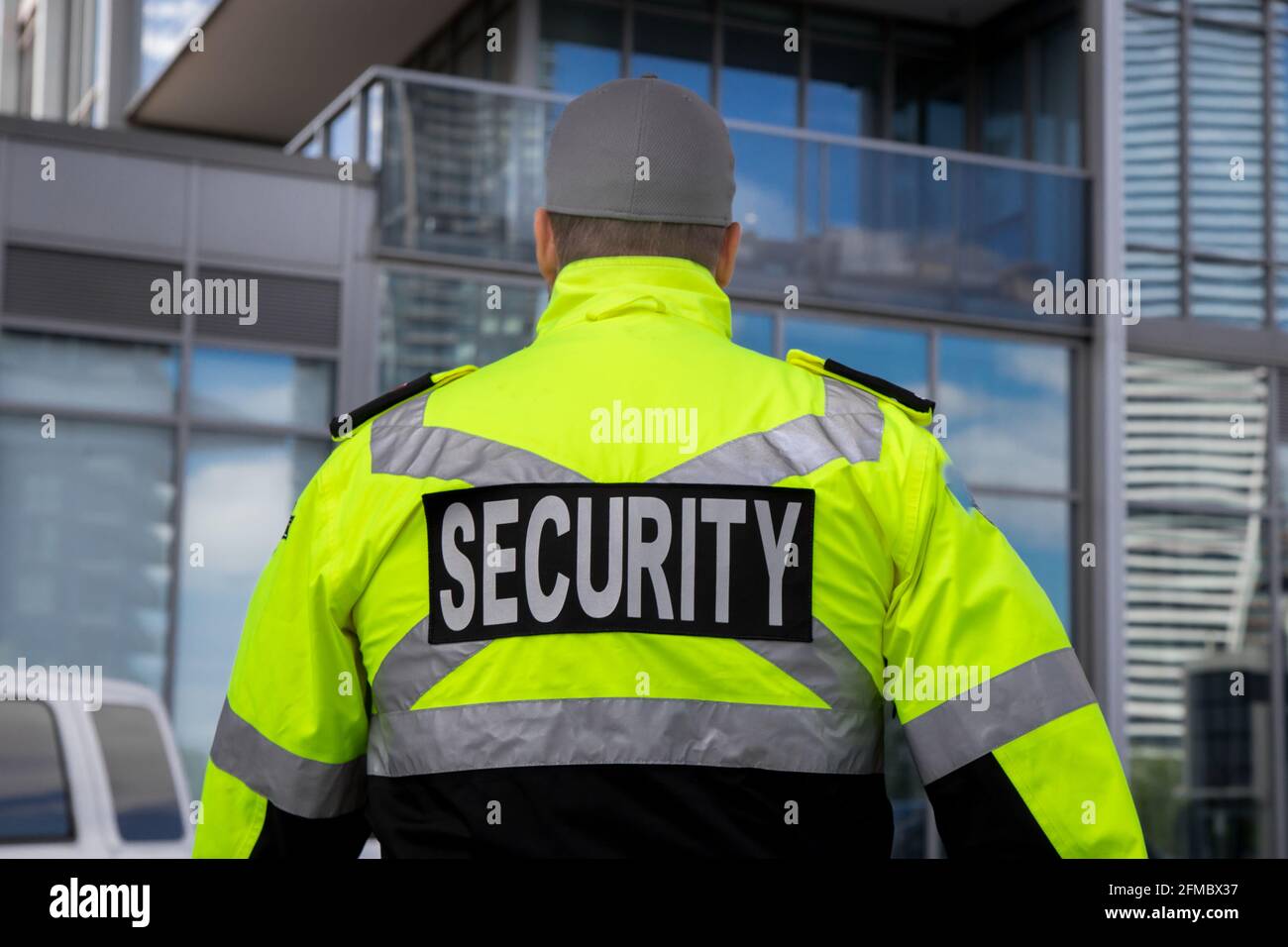 Tall security guard in a uniform patrolling condo area Stock Photo - Alamy
