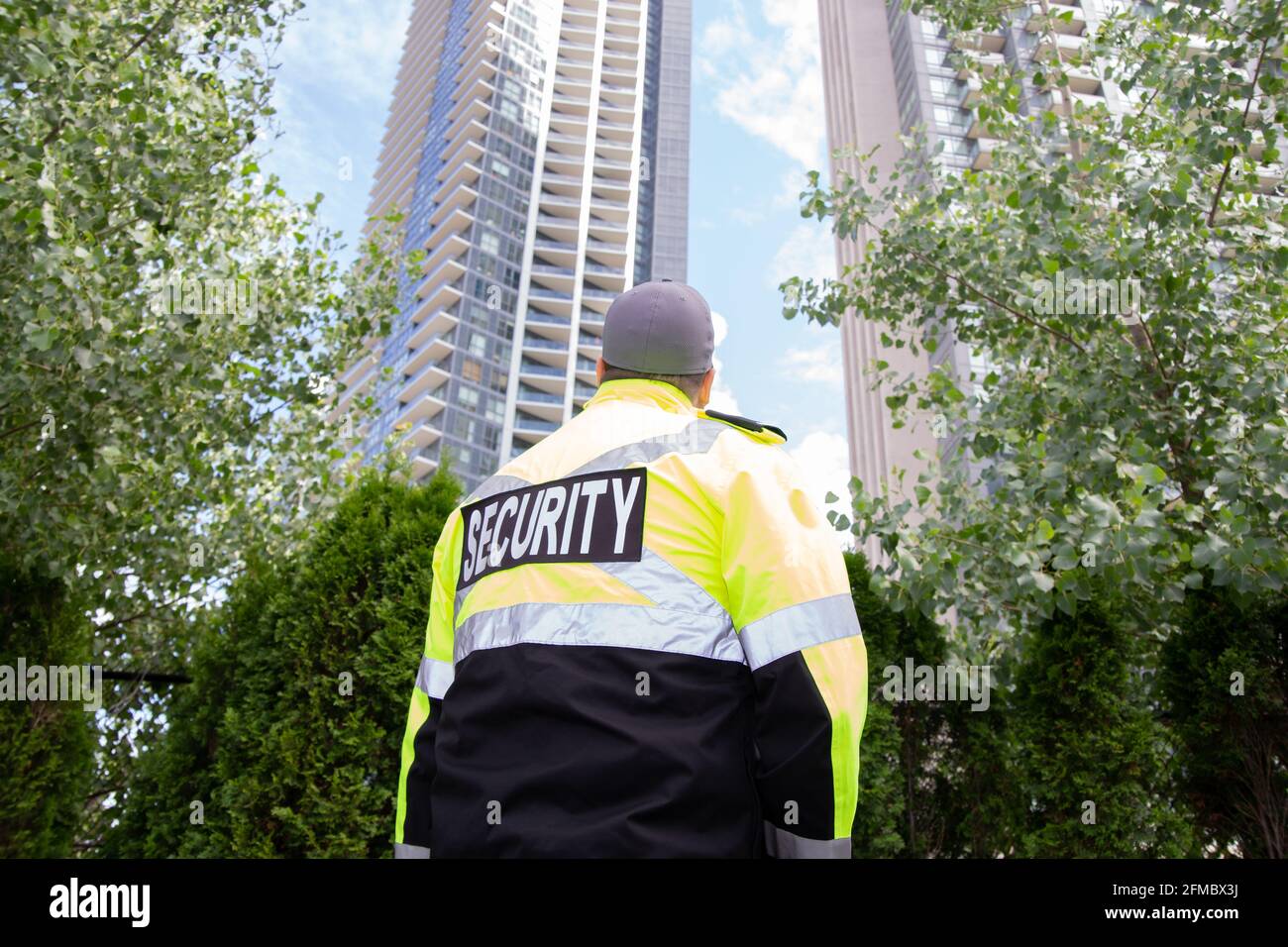 Tall security guard in a uniform patrolling condo area Stock Photo - Alamy