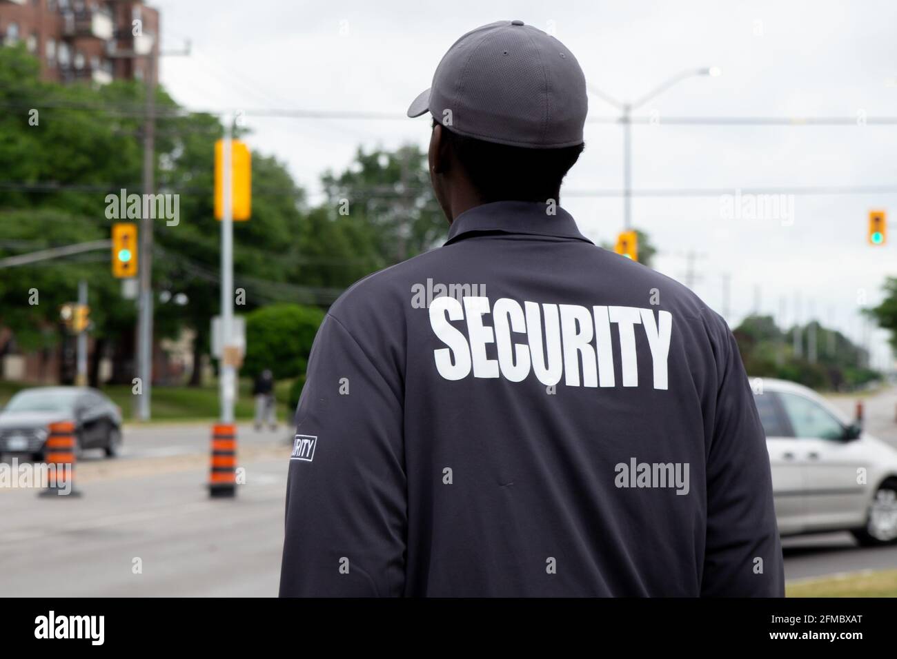 Black security guard in uniform patrolling busy street daytime Stock ...