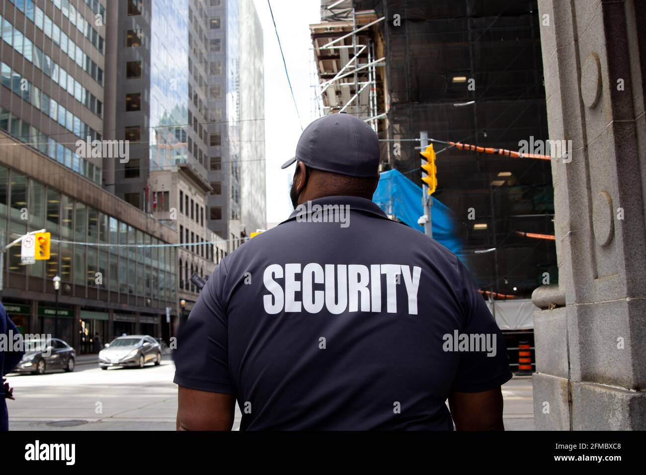 Black security guard in uniform patrolling busy street daytime Stock ...